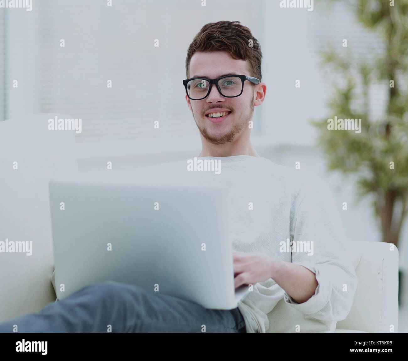 Young man using his laptop, close up Stock Photo - Alamy