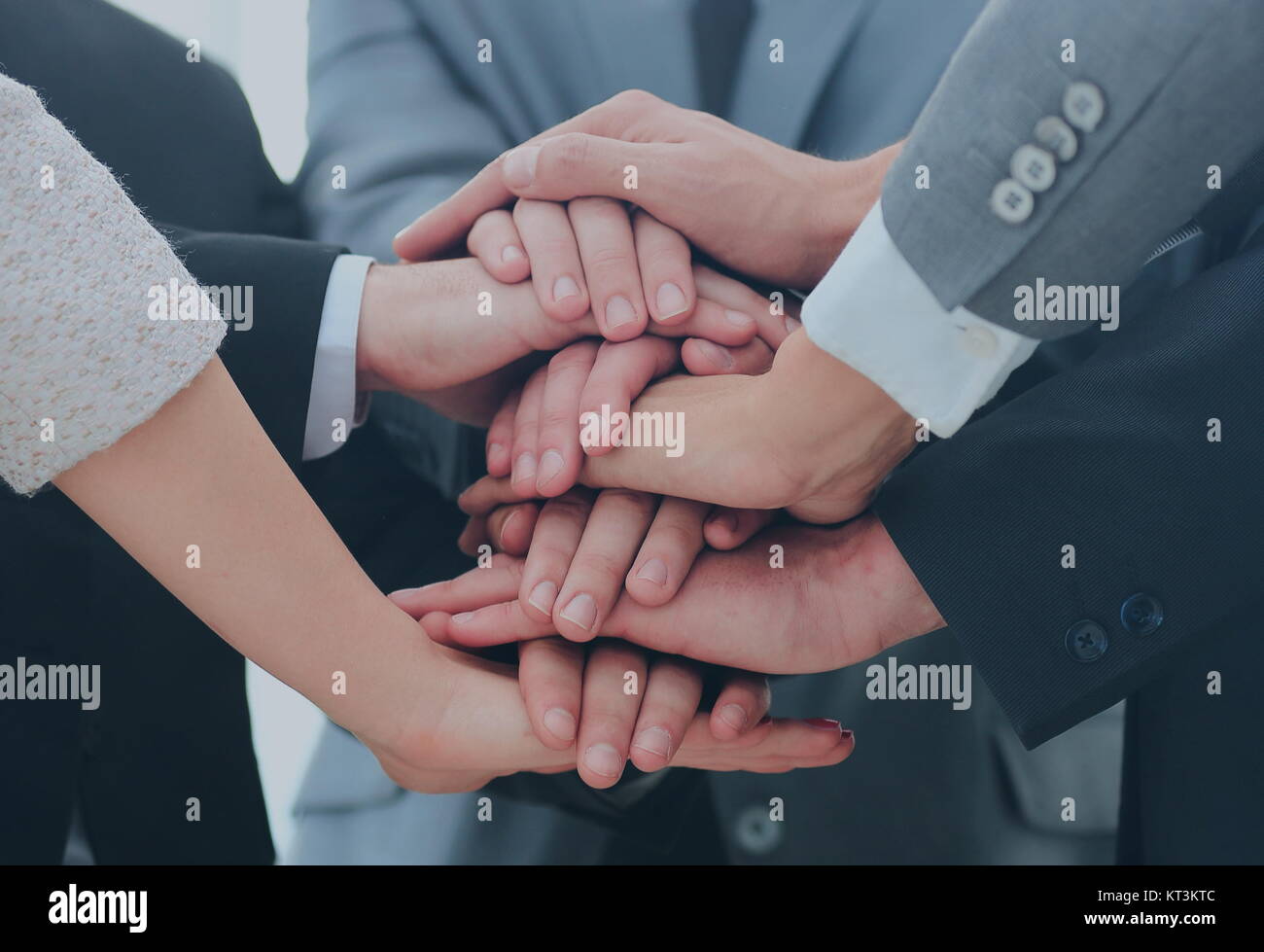 Business team joining hands together Stock Photo - Alamy