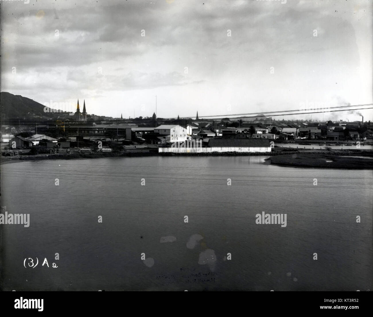 This photograph captures the city of Honolulu from its harbor ...