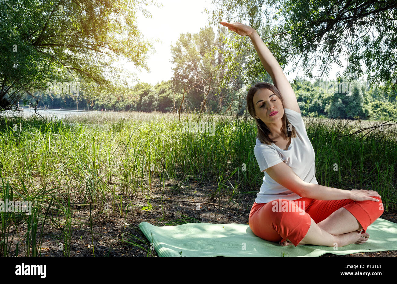 Young woman relaxing doing meditation on nature Stock Photo - Alamy