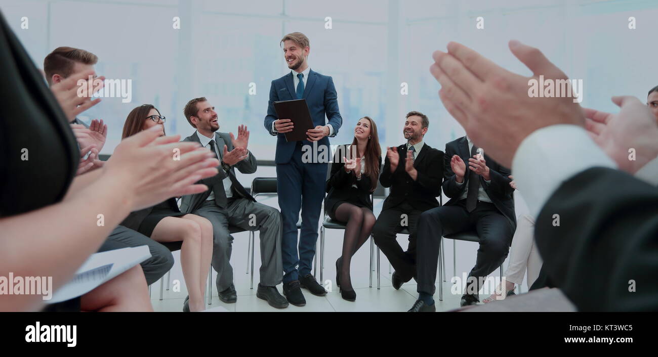 Business group greets leader with clapping and smiling Stock Photo - Alamy