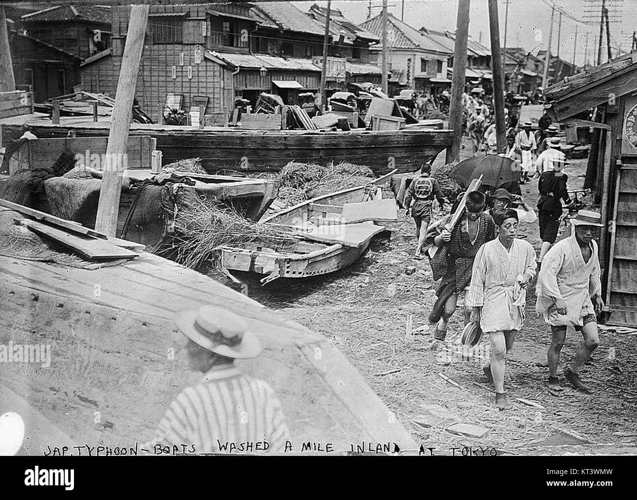 In this image, Japanese typhoon boats are shown washed a mile inland in ...