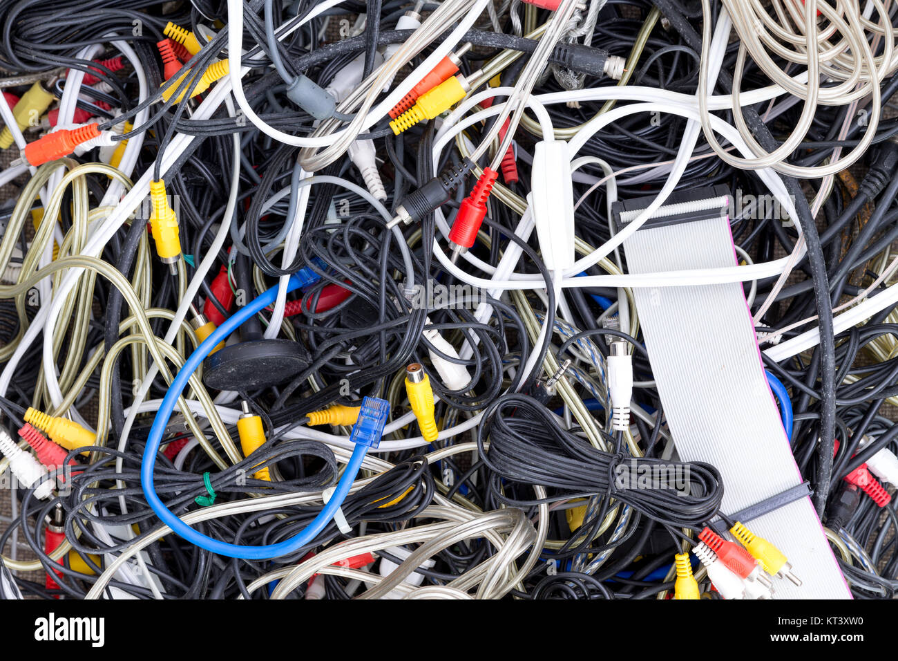 High-angle full frame close-up of many different tangled cables and ...