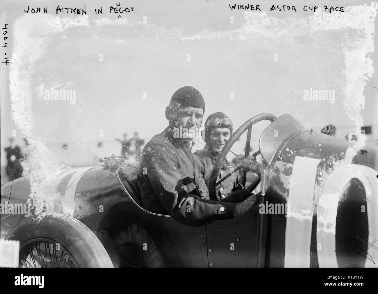 Johnny Aitken, a renowned early 20th-century driver, is shown racing a ...