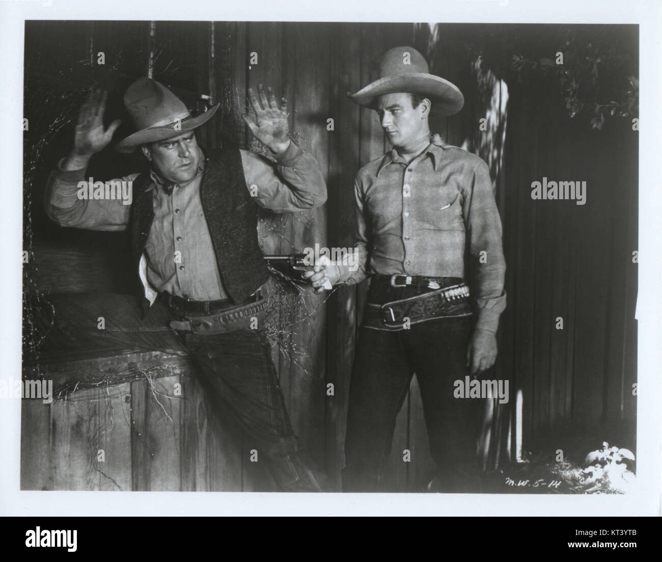 John Wayne, an iconic American actor, is pictured with a gun. Known for ...