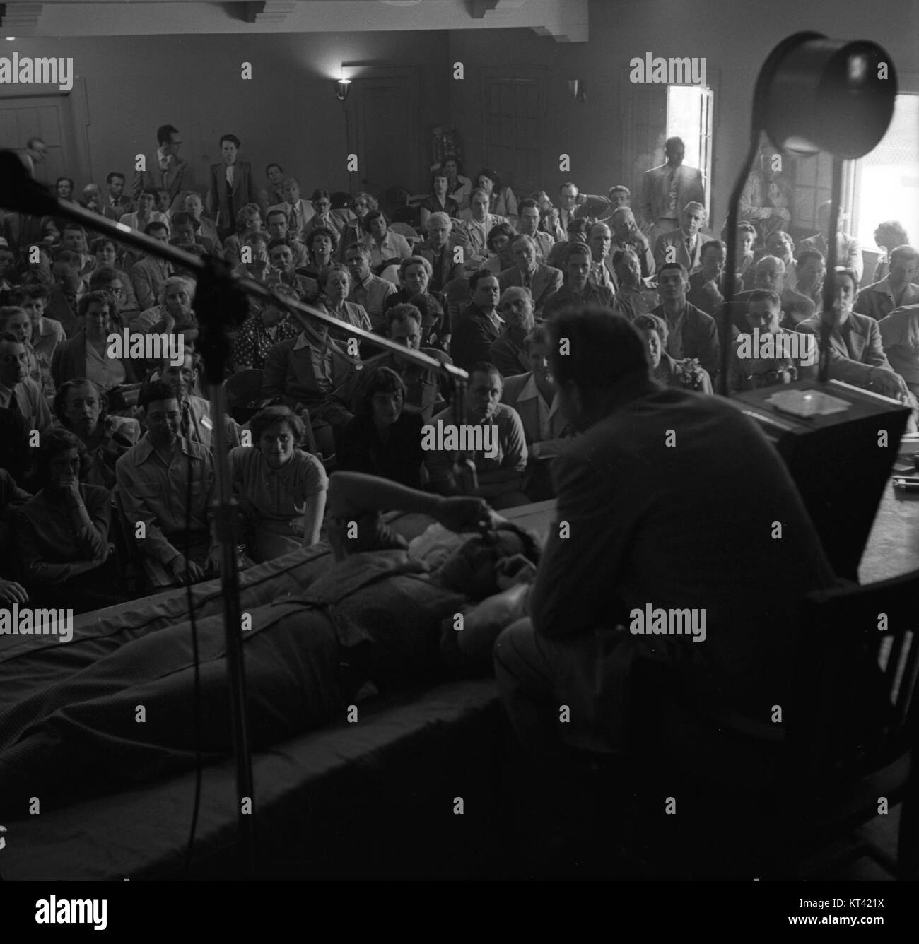 L. Ron Hubbard, the founder of Scientology, is shown conducting a ...