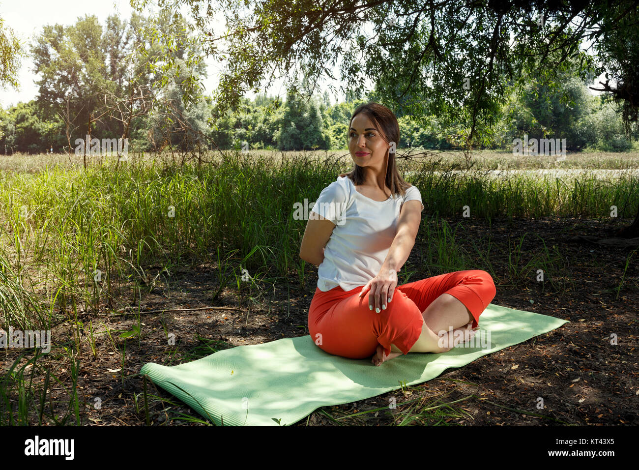 yoga and relax –smiling woman in nature in yoga pose Stock Photo - Alamy