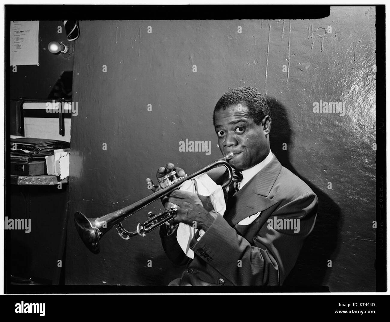 This black-and-white photograph captures jazz musician Louis Armstrong ...