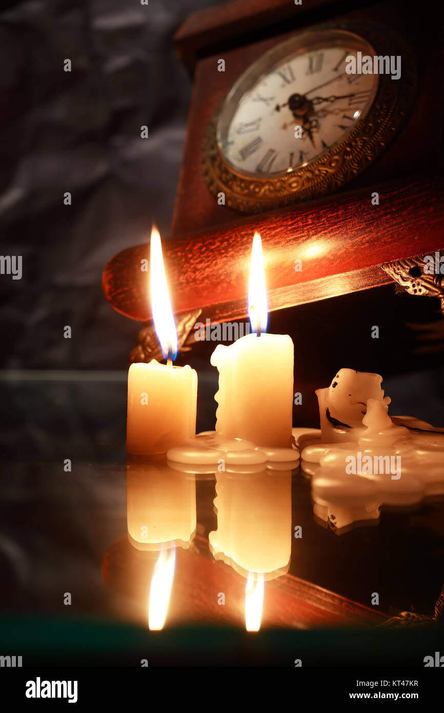 Vintage still life with lighting candles near old clock Stock Photo - Alamy