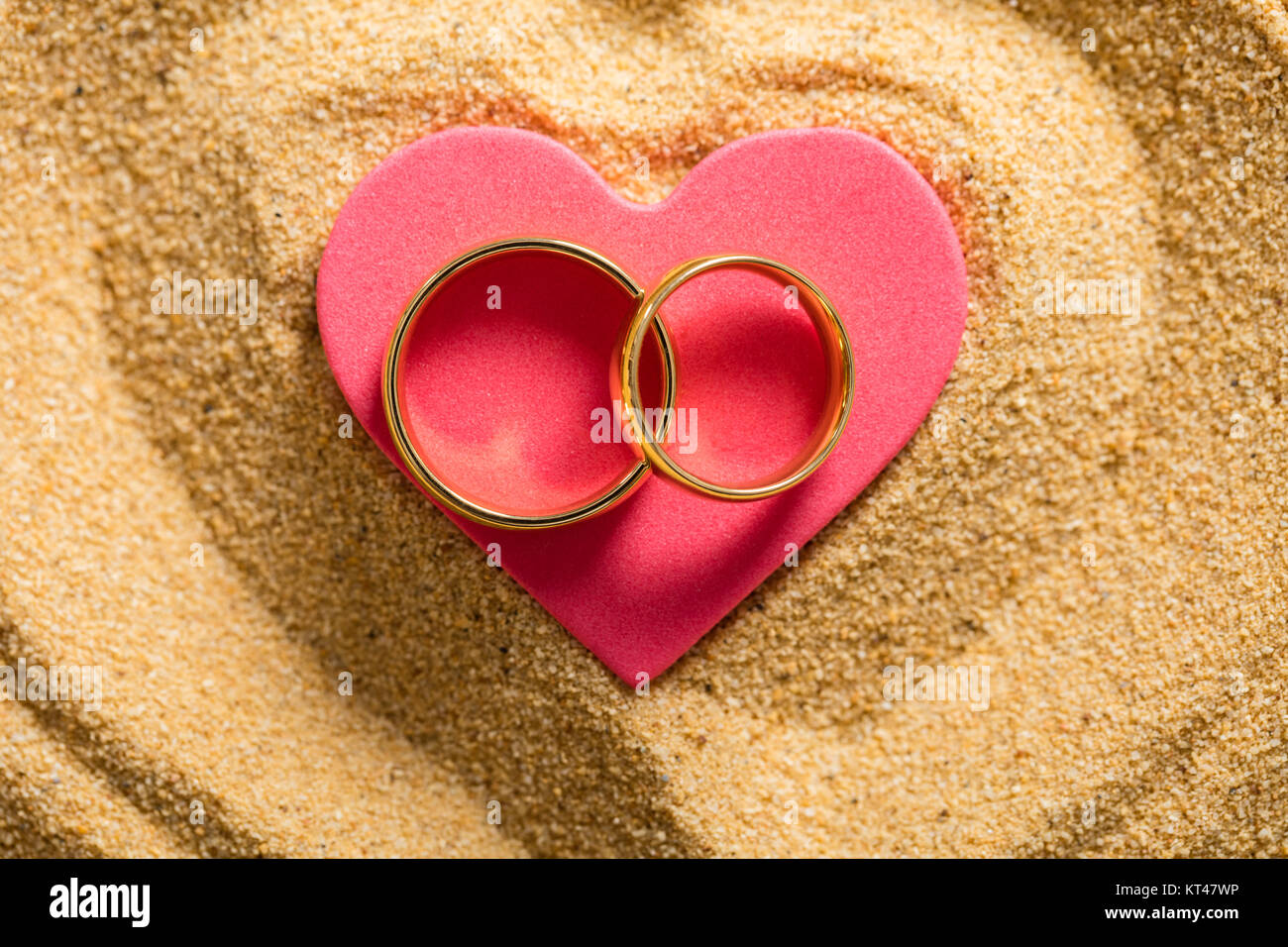An Wedding Rings On A Heart Shape Stock Photo - Alamy