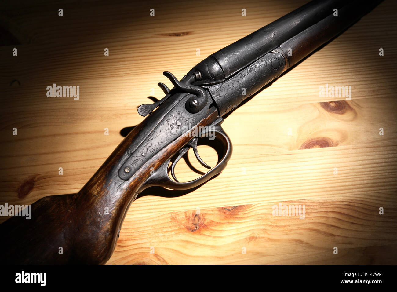 Ancient hunting shotgun closeup on wooden board under light beam Stock ...