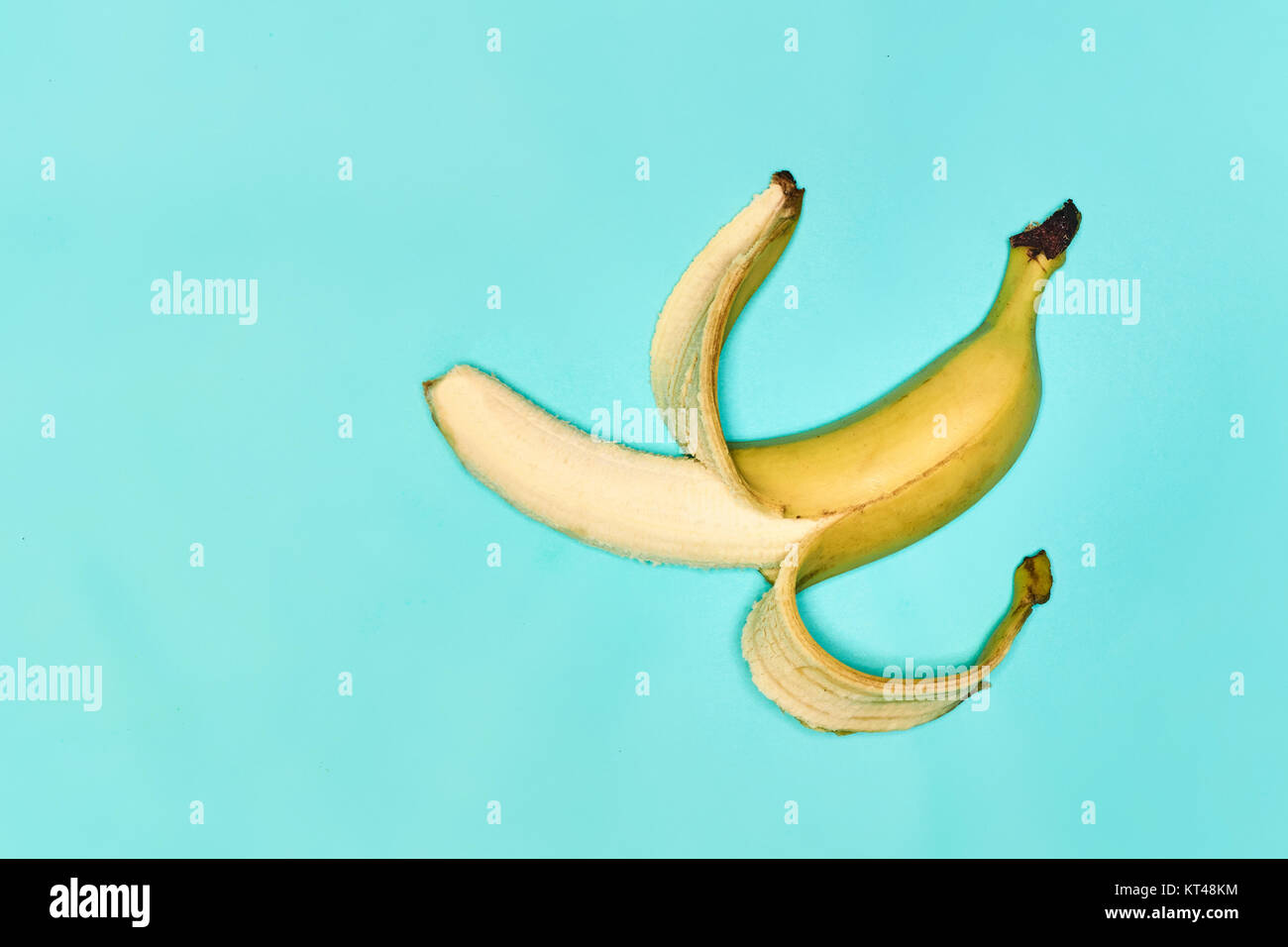 Single banana against blue background Stock Photo - Alamy