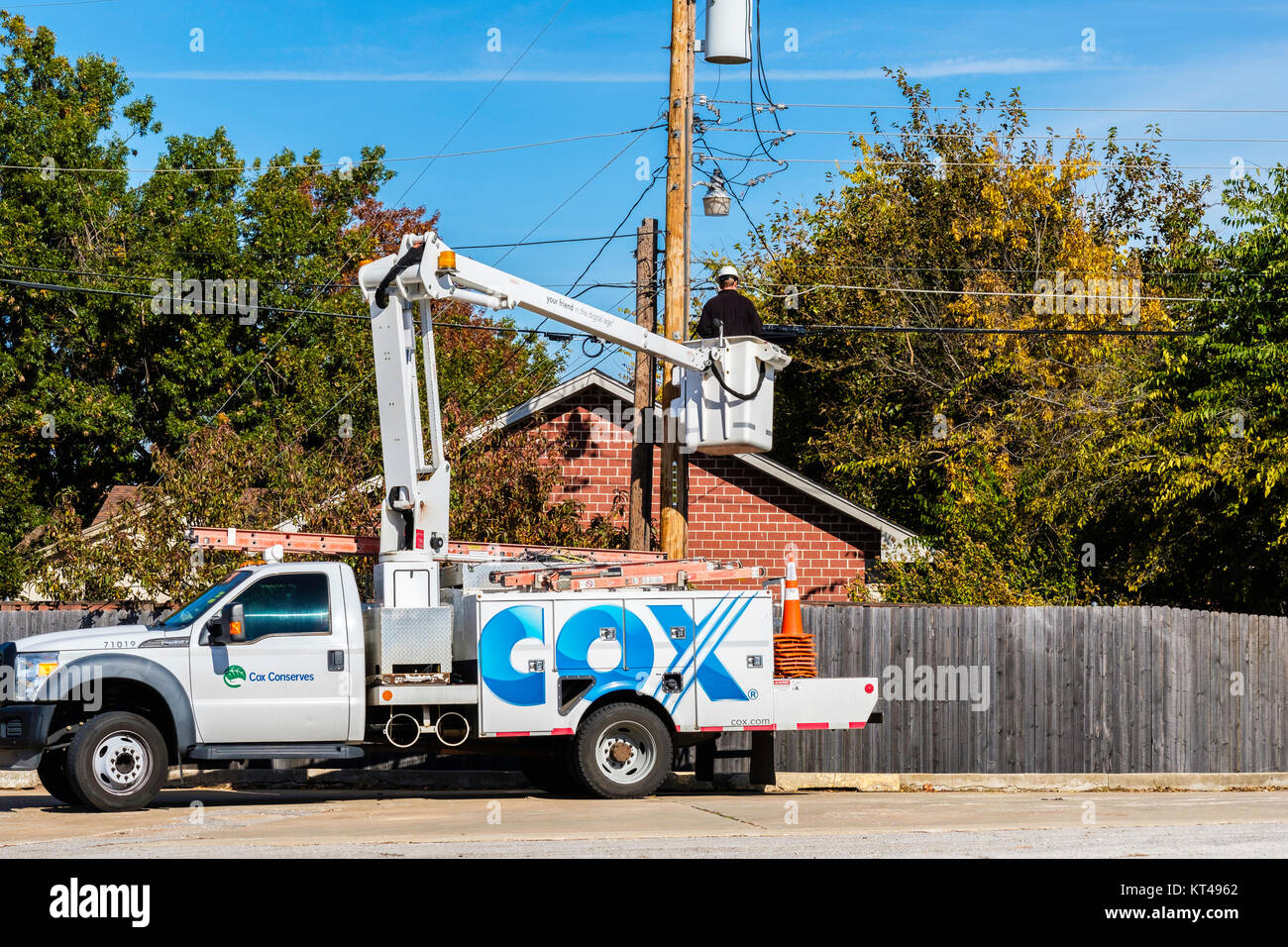 A Cox Communication employee services a line providing ISP services ...