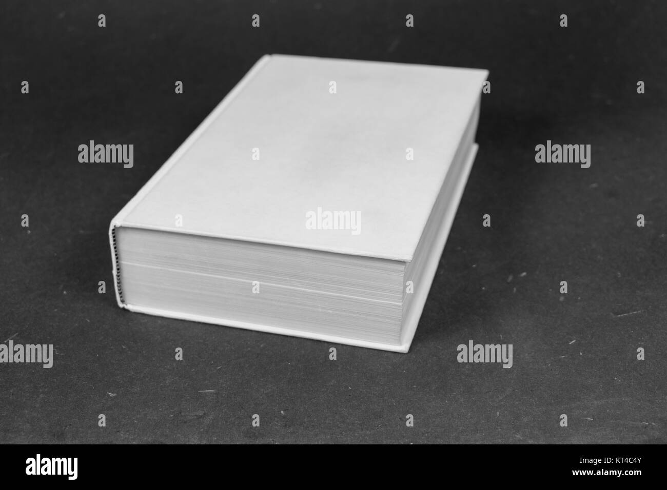 Black and white image of white hardcover book with white pages. Clean ...