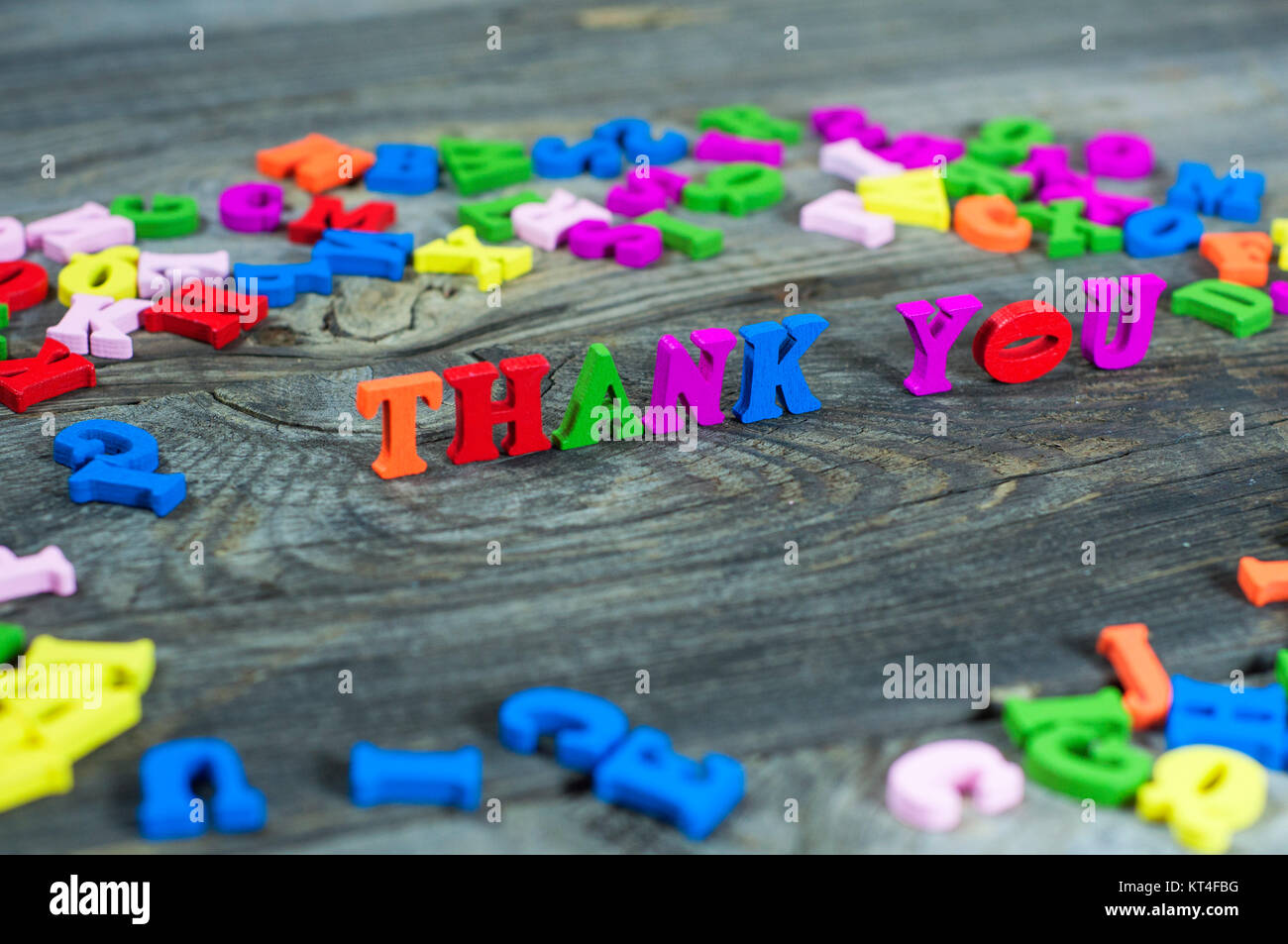 Colorful wooden letters on a gray surface Stock Photo - Alamy
