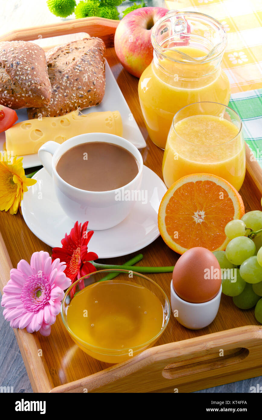 Breakfast on tray served with coffee, juice, egg, and rolls Stock Photo - Alamy