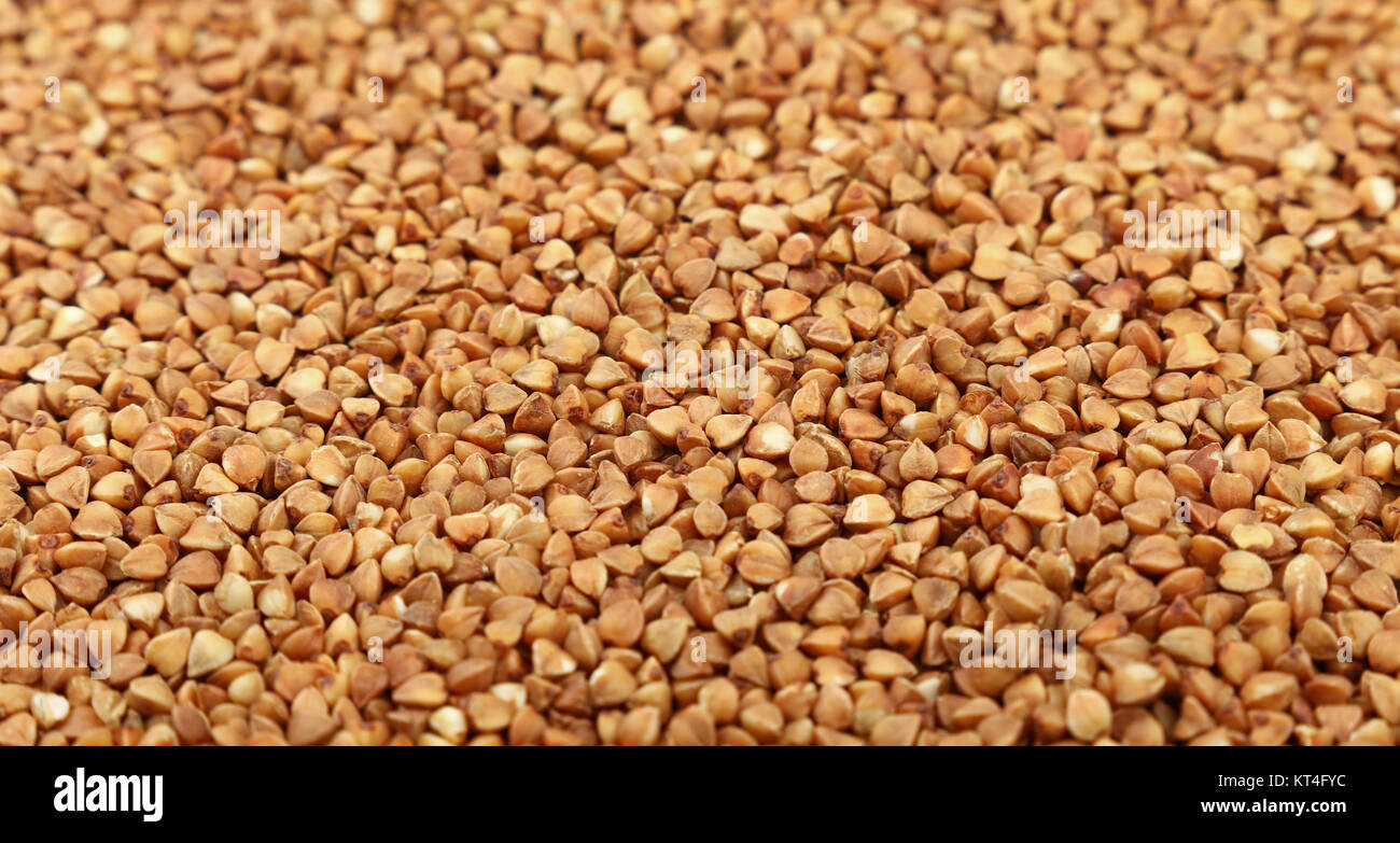 Dried brown buckwheat groats close up background Stock Photo - Alamy