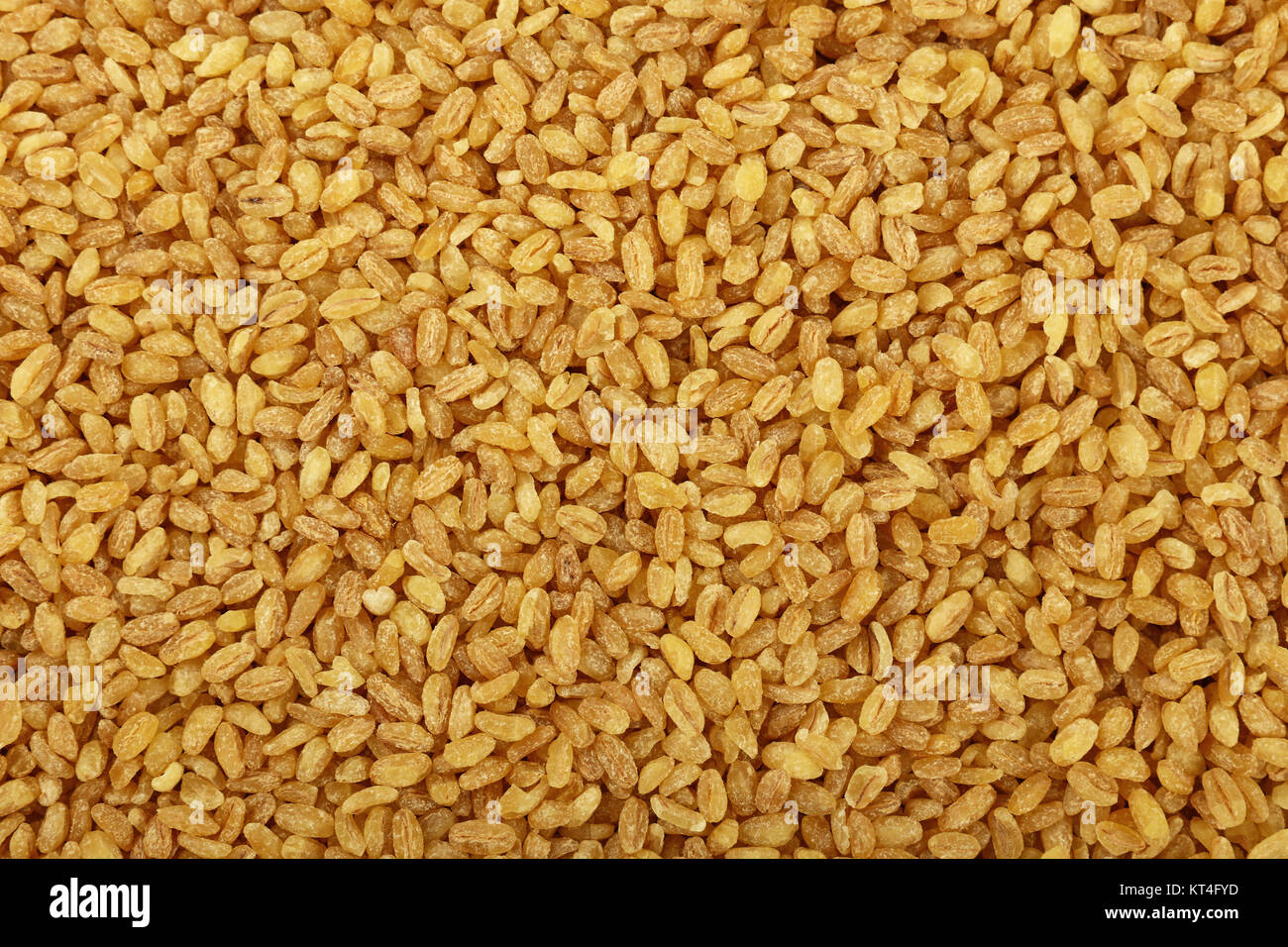 Yellow bulgur big grains close up background Stock Photo - Alamy