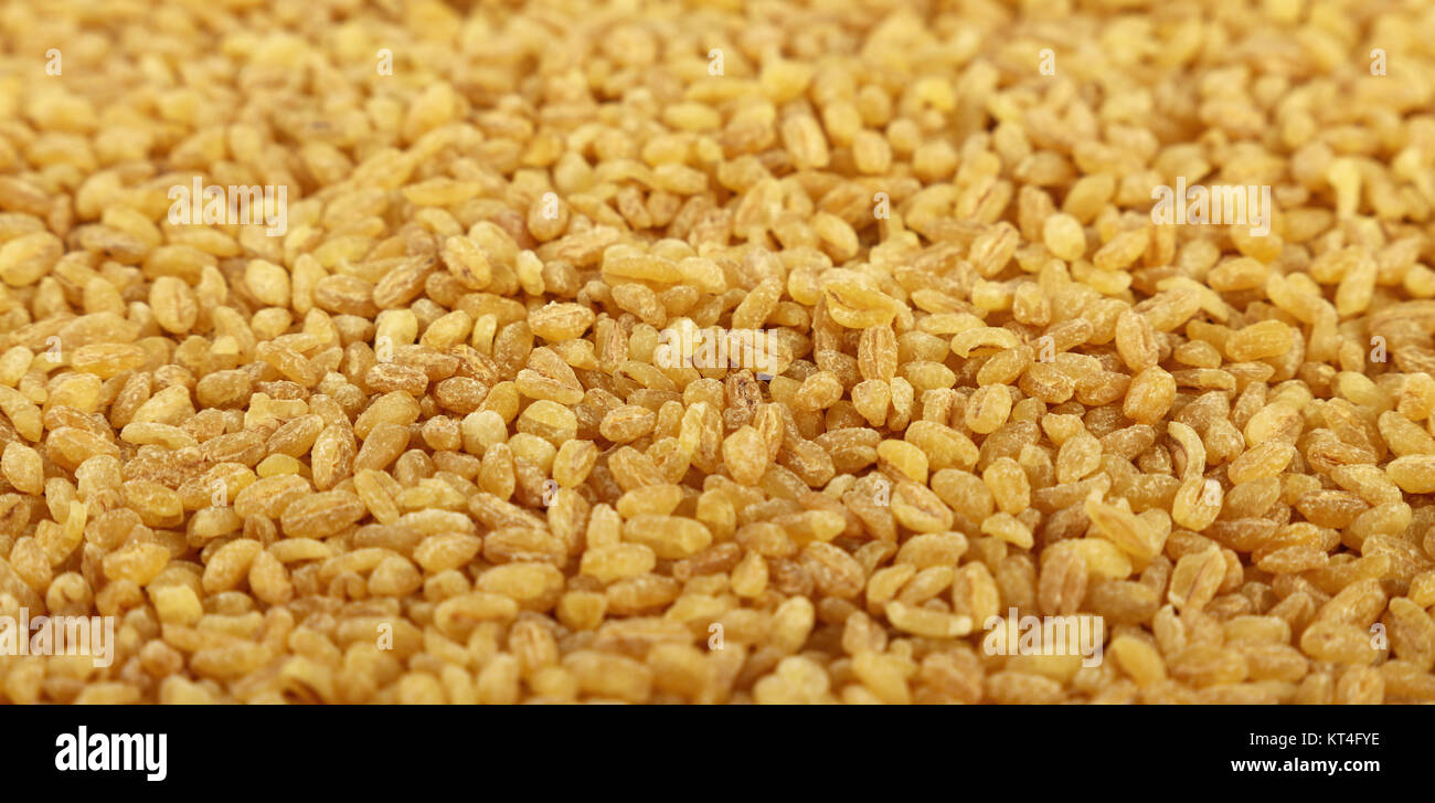 Yellow bulgur big grains close up background Stock Photo - Alamy