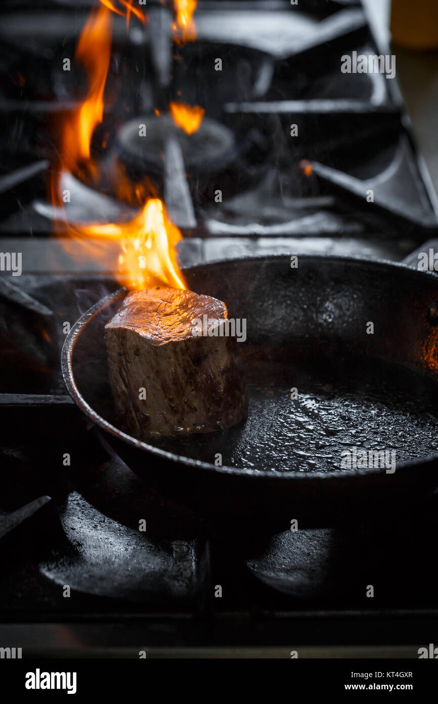 Piece of meat in fire Stock Photo - Alamy