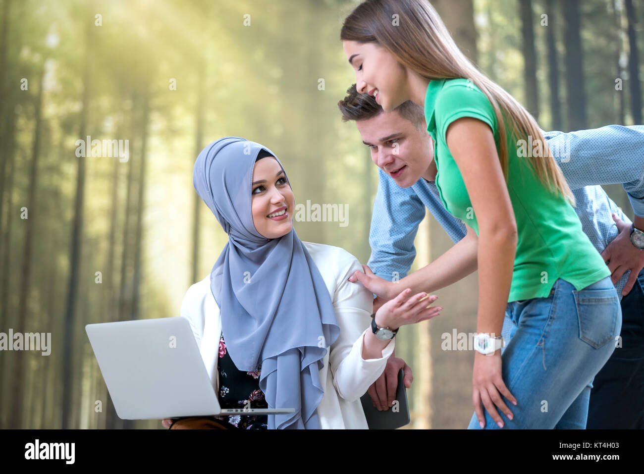 diverse college students using laptop and talking, learning exchanging ...