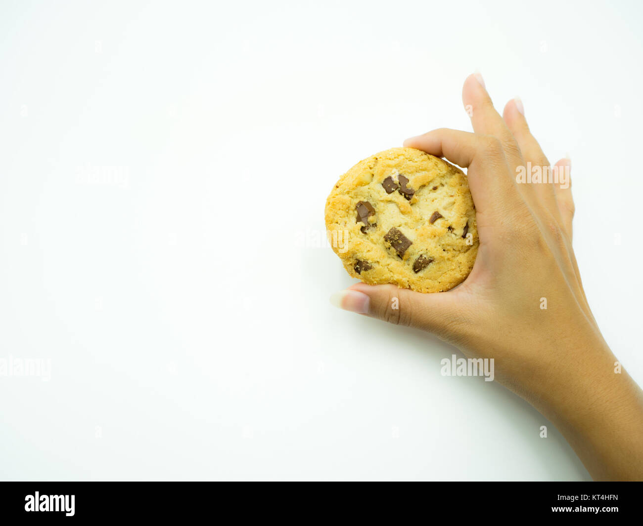 Woman's hand holding chocolate chip cookies Stock Photo - Alamy