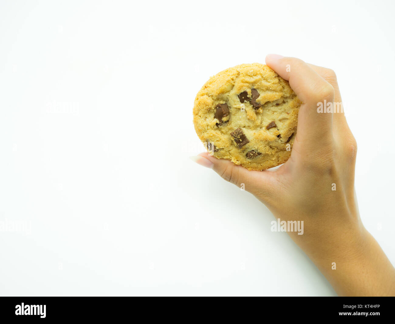 Woman's hand holding stack of chocolate chip cookies Stock Photo - Alamy