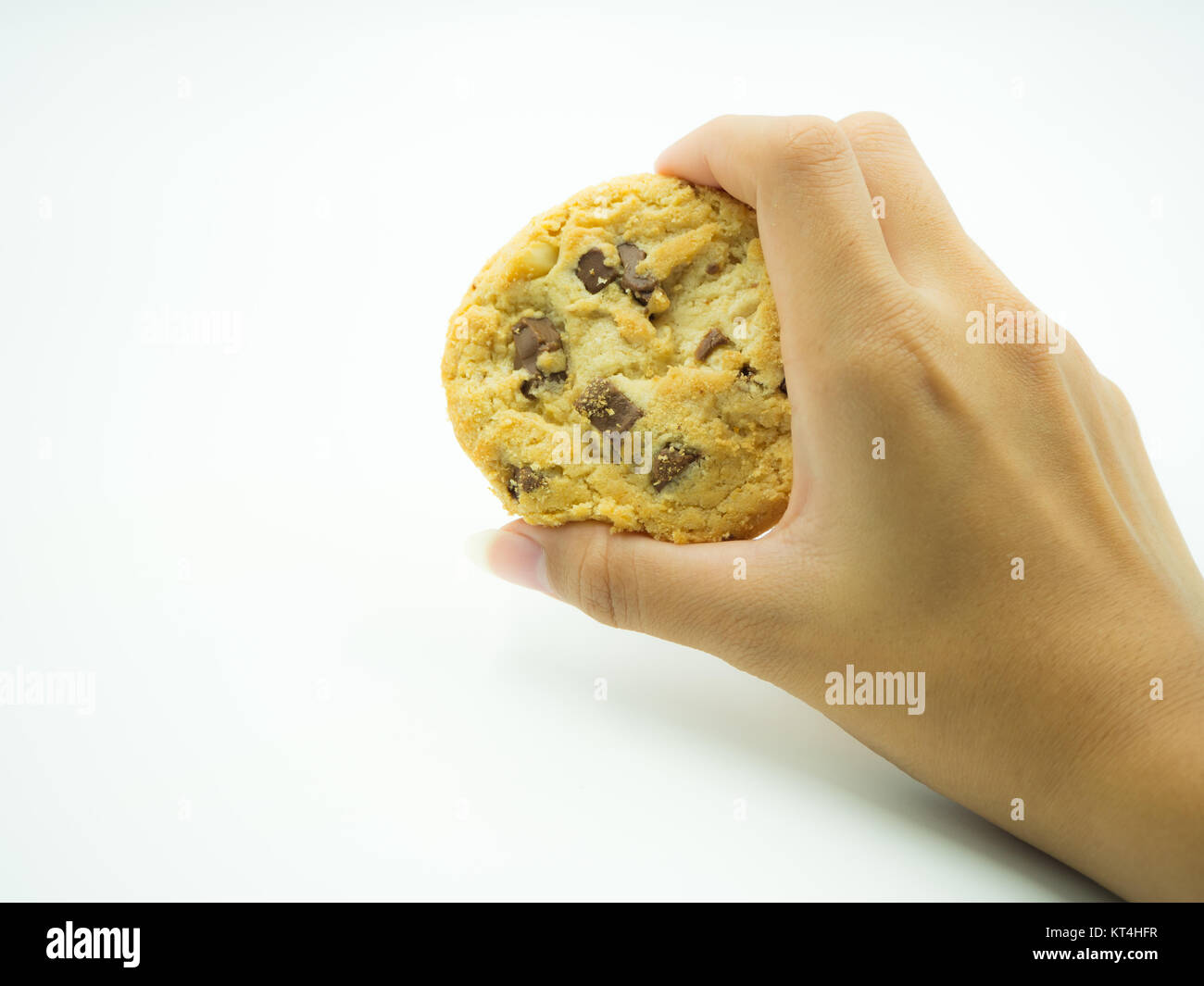 Woman's hand holding stack of chocolate chip cookies Stock Photo - Alamy