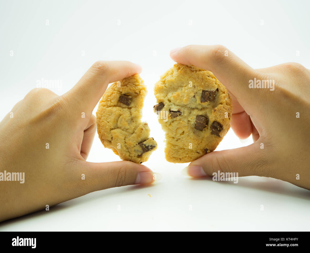 Woman's hand holding stack of chocolate chip cookies Stock Photo - Alamy