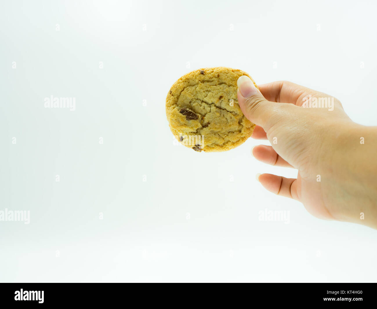Woman's hand holding stack of chocolate chip cookies Stock Photo - Alamy