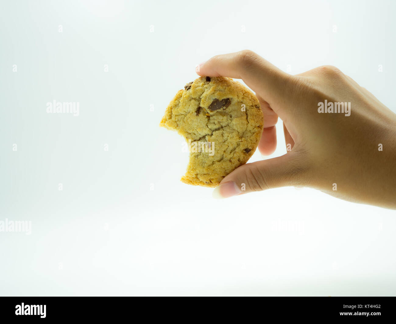Woman's hand holding stack of chocolate chip cookies Stock Photo - Alamy