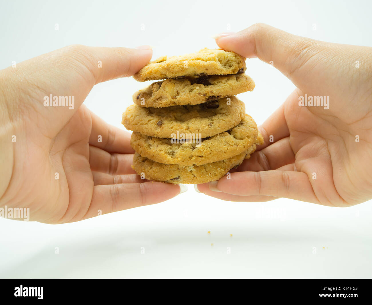 Woman's hand holding stack of chocolate chip cookies Stock Photo - Alamy