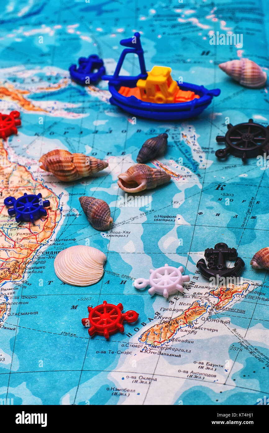 Symbolic toy ship on a topographic map of the world Stock Photo - Alamy
