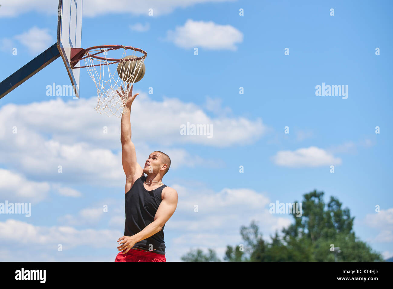 Basketball player in action flying high and scoring Stock Photo - Alamy