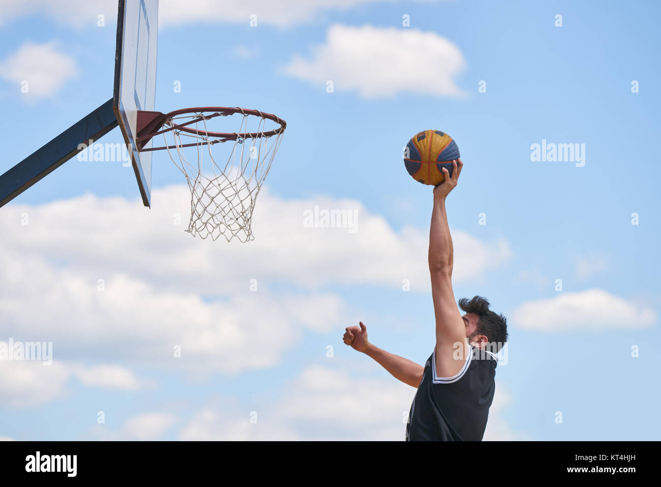 Basketball player in action flying high and scoring Stock Photo - Alamy
