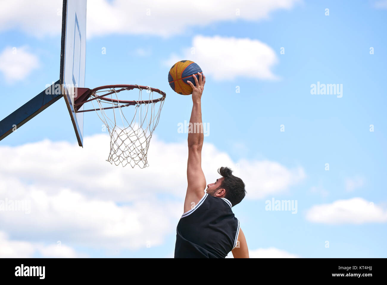 Basketball player in action flying high and scoring Stock Photo - Alamy