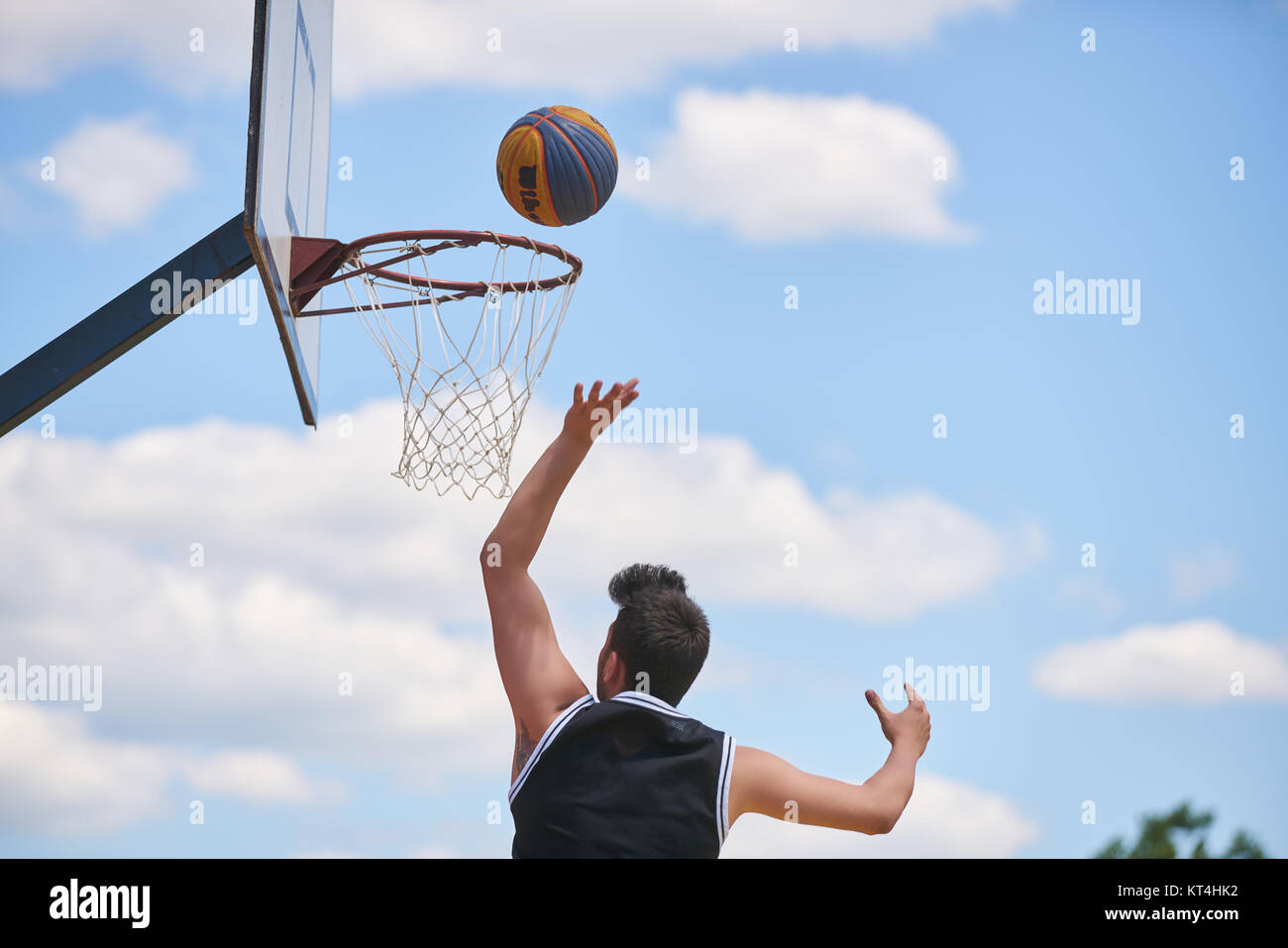 Basketball player in action flying high and scoring Stock Photo - Alamy