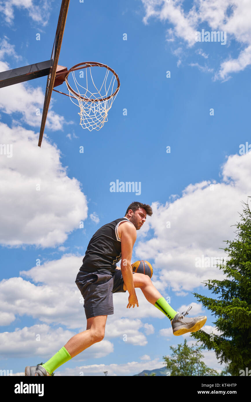 Basketball player in action flying high and scoring Stock Photo - Alamy
