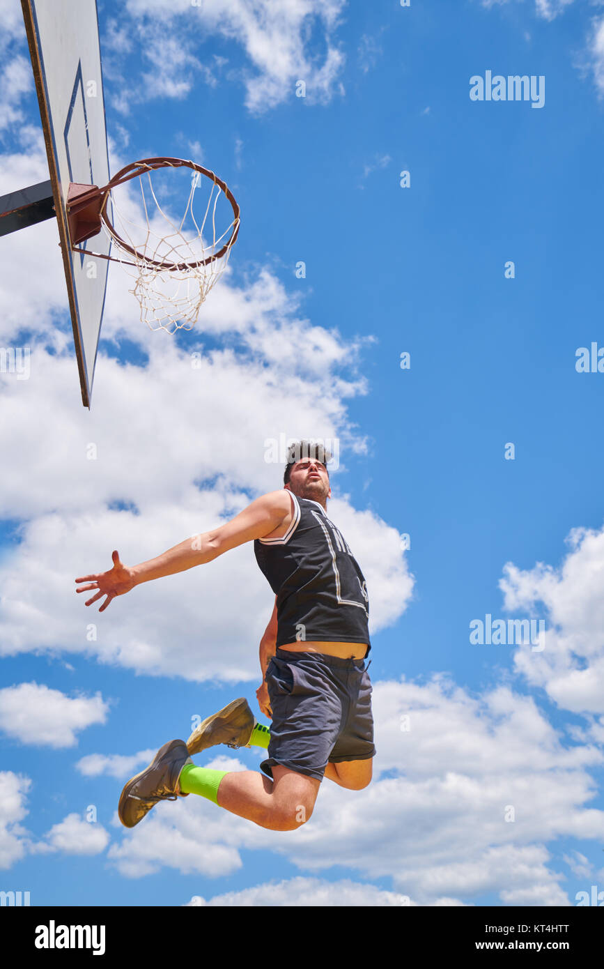 Basketball player in action flying high and scoring Stock Photo - Alamy