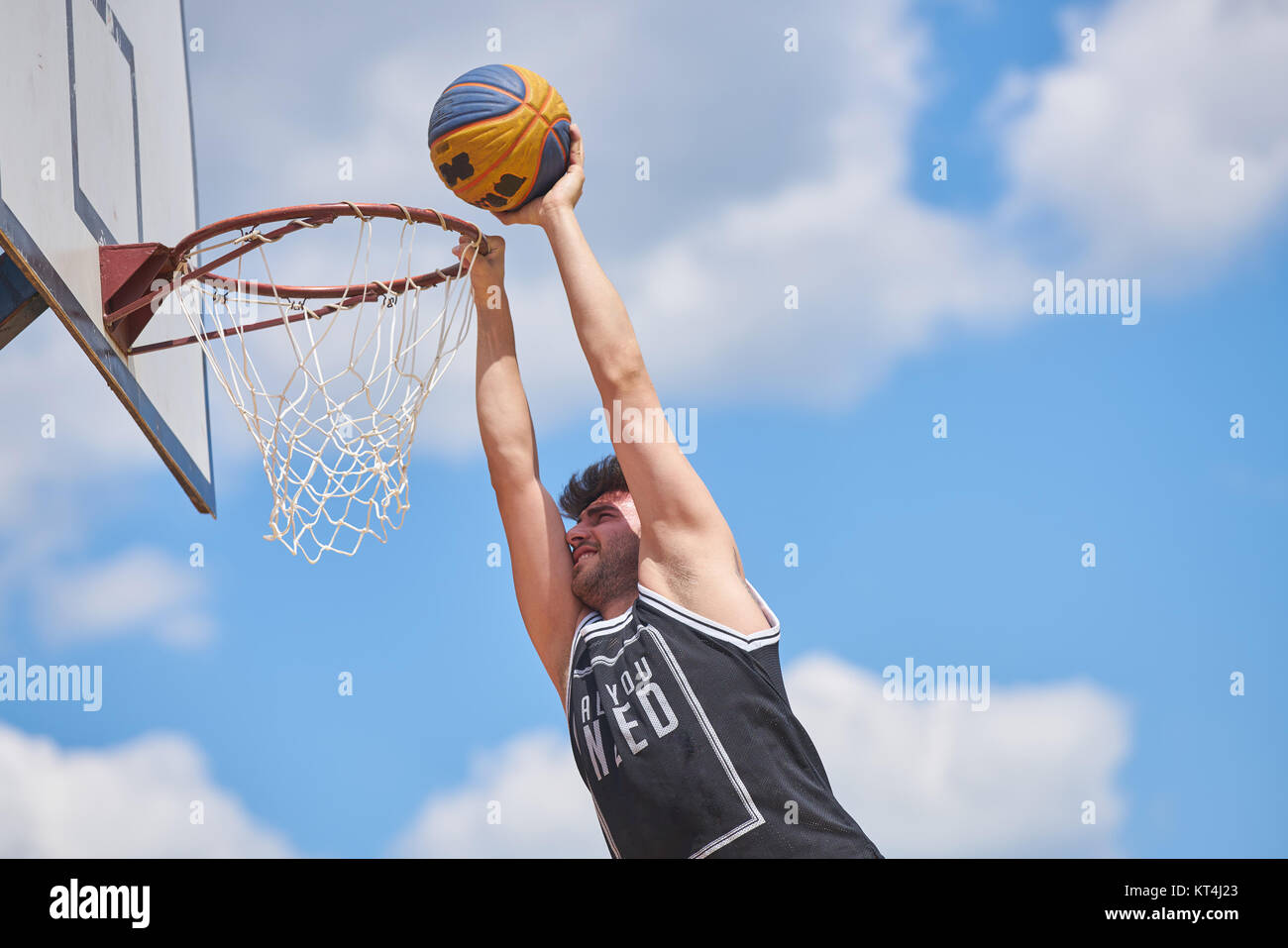 Basketball player in action flying high and scoring Stock Photo - Alamy