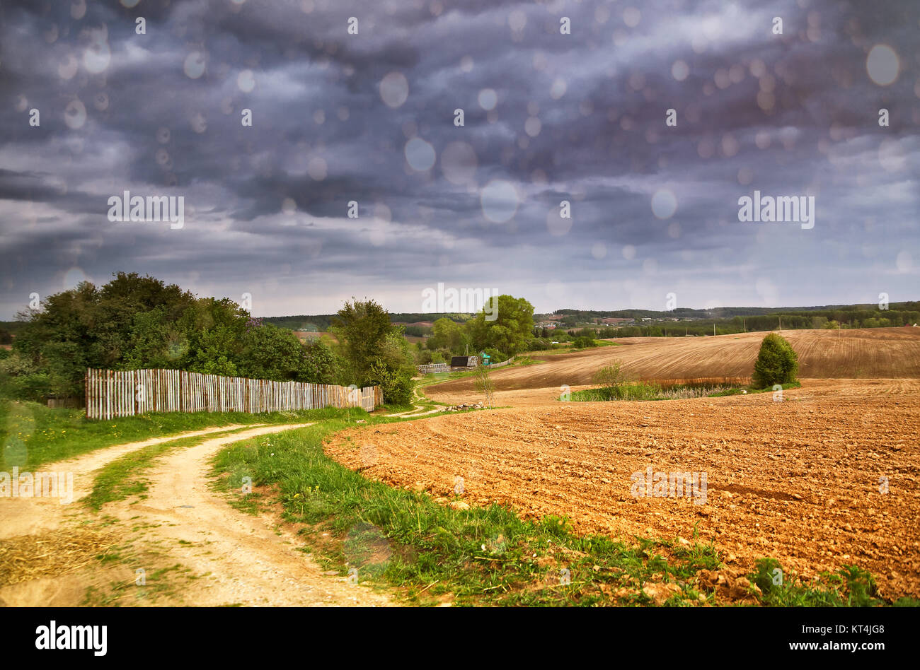Rain. Spring storm clouds above country road Stock Photo - Alamy