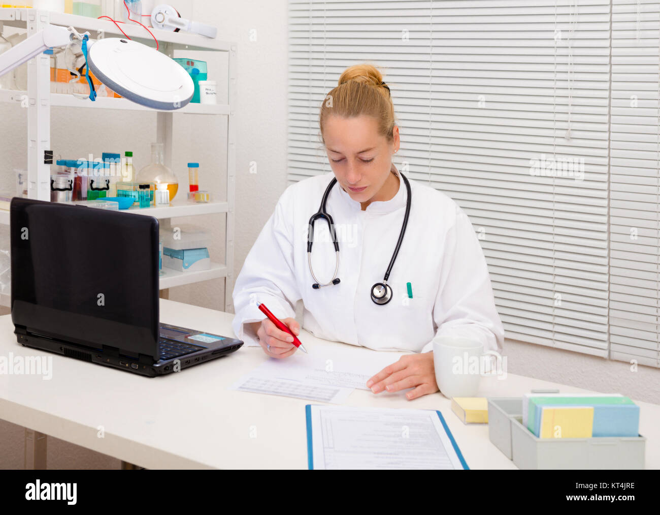 Experienced medical practitioner checks patients records Stock Photo ...