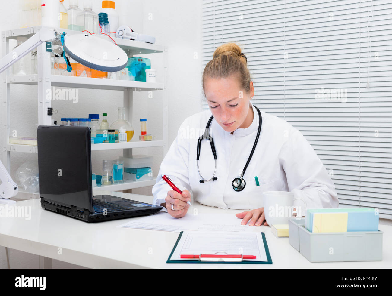 Experienced medical practitioned checks patients records Stock Photo ...