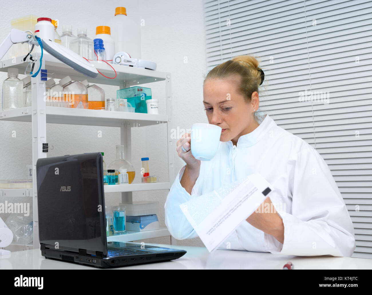 Experienced scientist drinks coffe while reading scientific publication ...