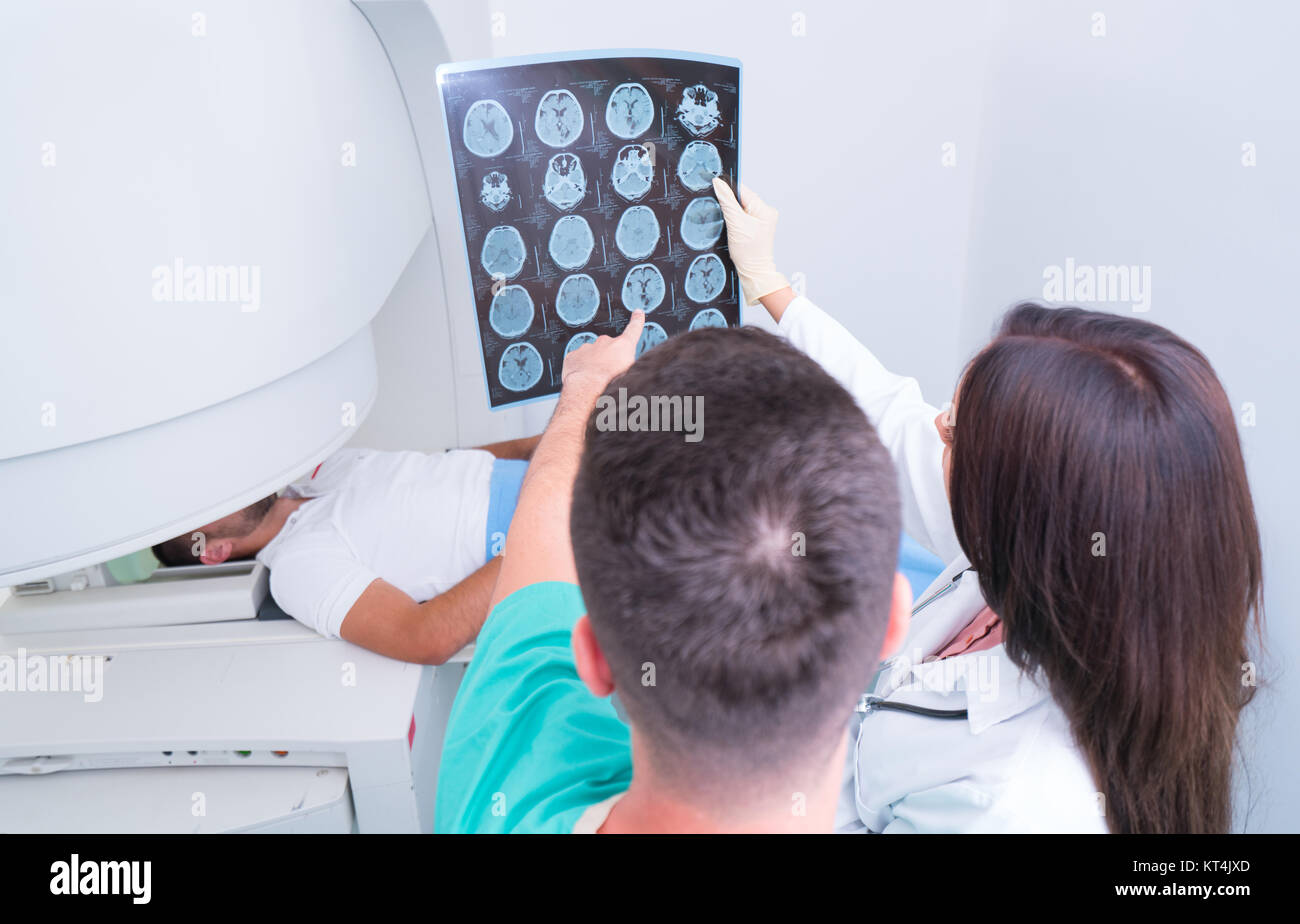 Confident pleasant doctor working with MRI scan results Stock Photo - Alamy