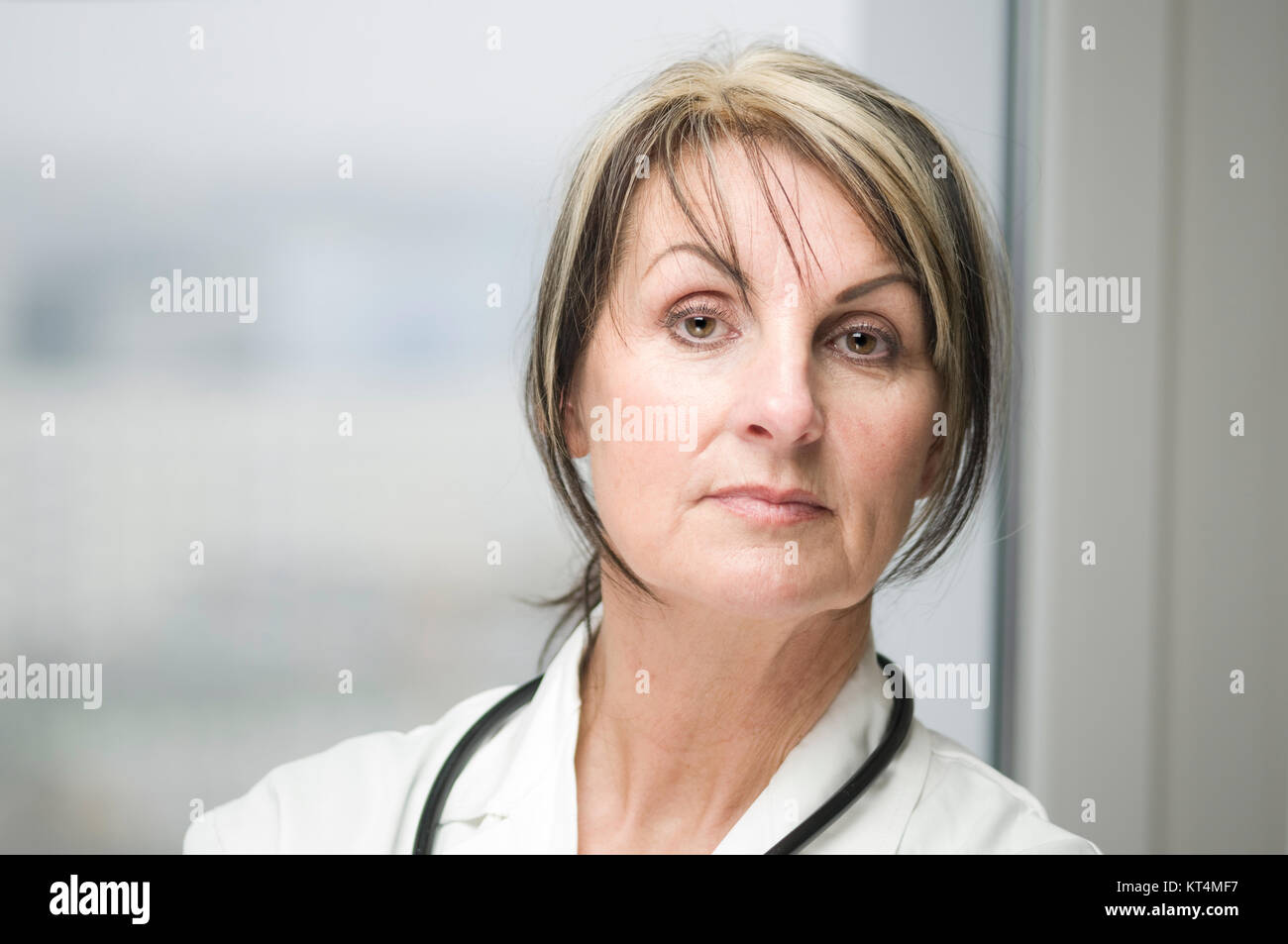 lady doc by the window Stock Photo - Alamy