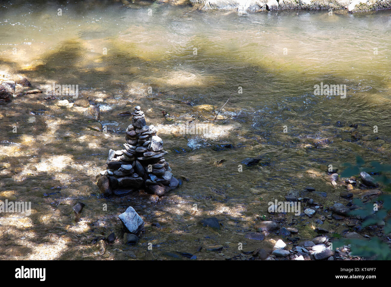 cairns in a river in a forest in styria in summer in a nature reserve ...