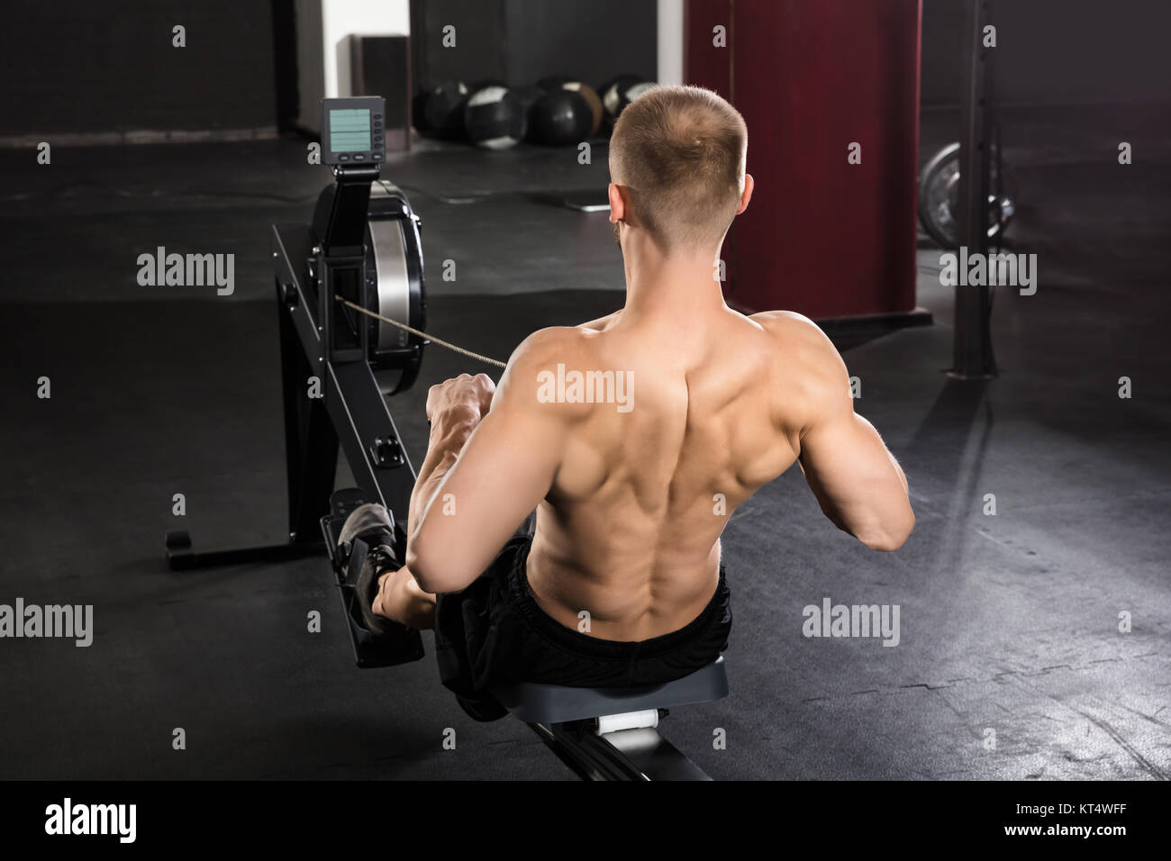 Man Working Out On Row Machine Stock Photo - Alamy