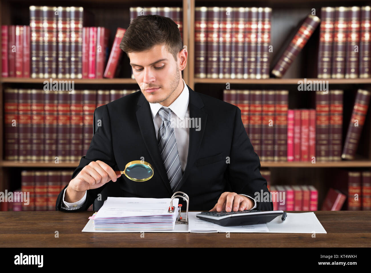 Male Auditor Scrutinizing Bills Stock Photo - Alamy