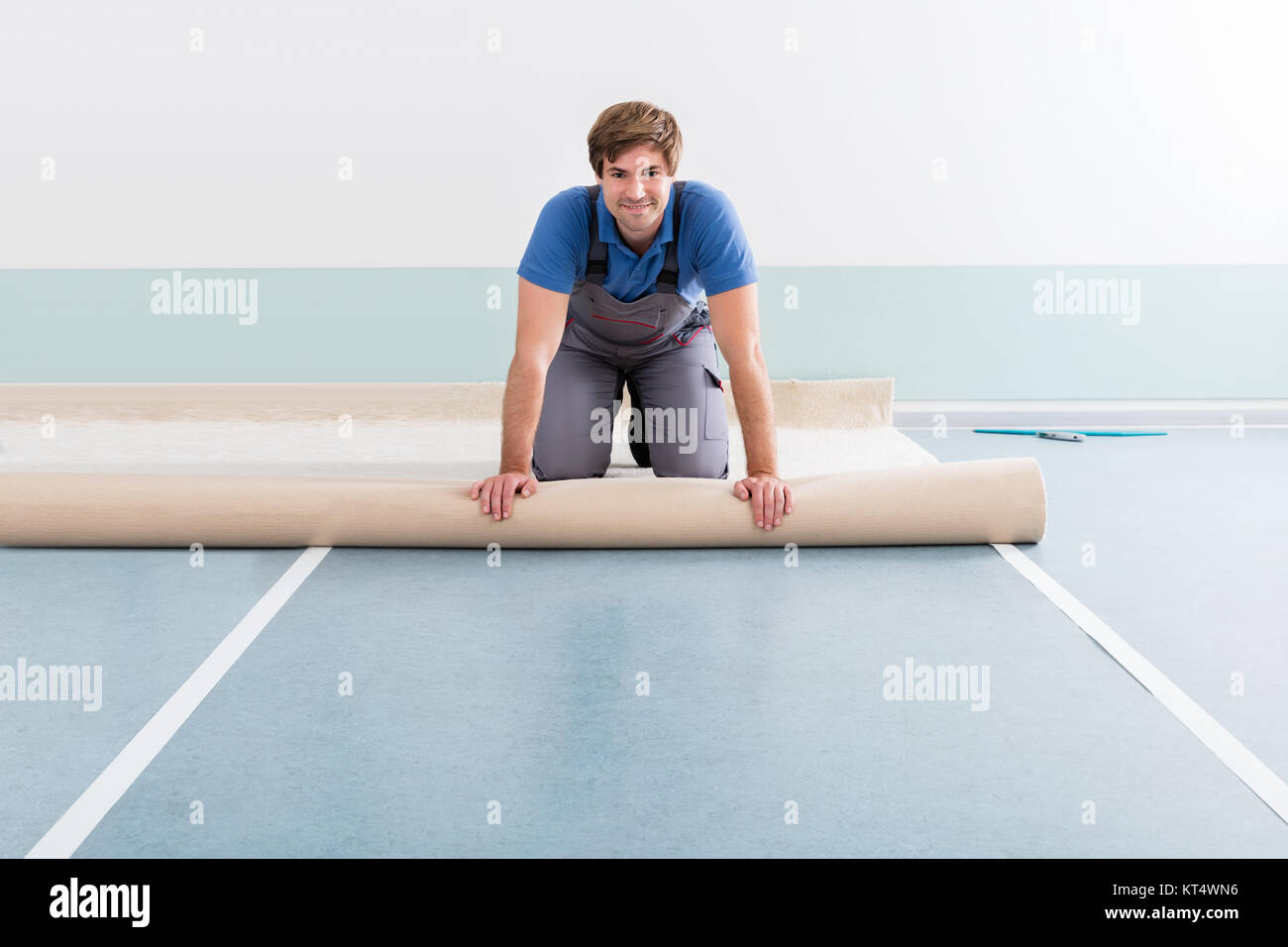 Young Man Laying Carpet Stock Photo - Alamy